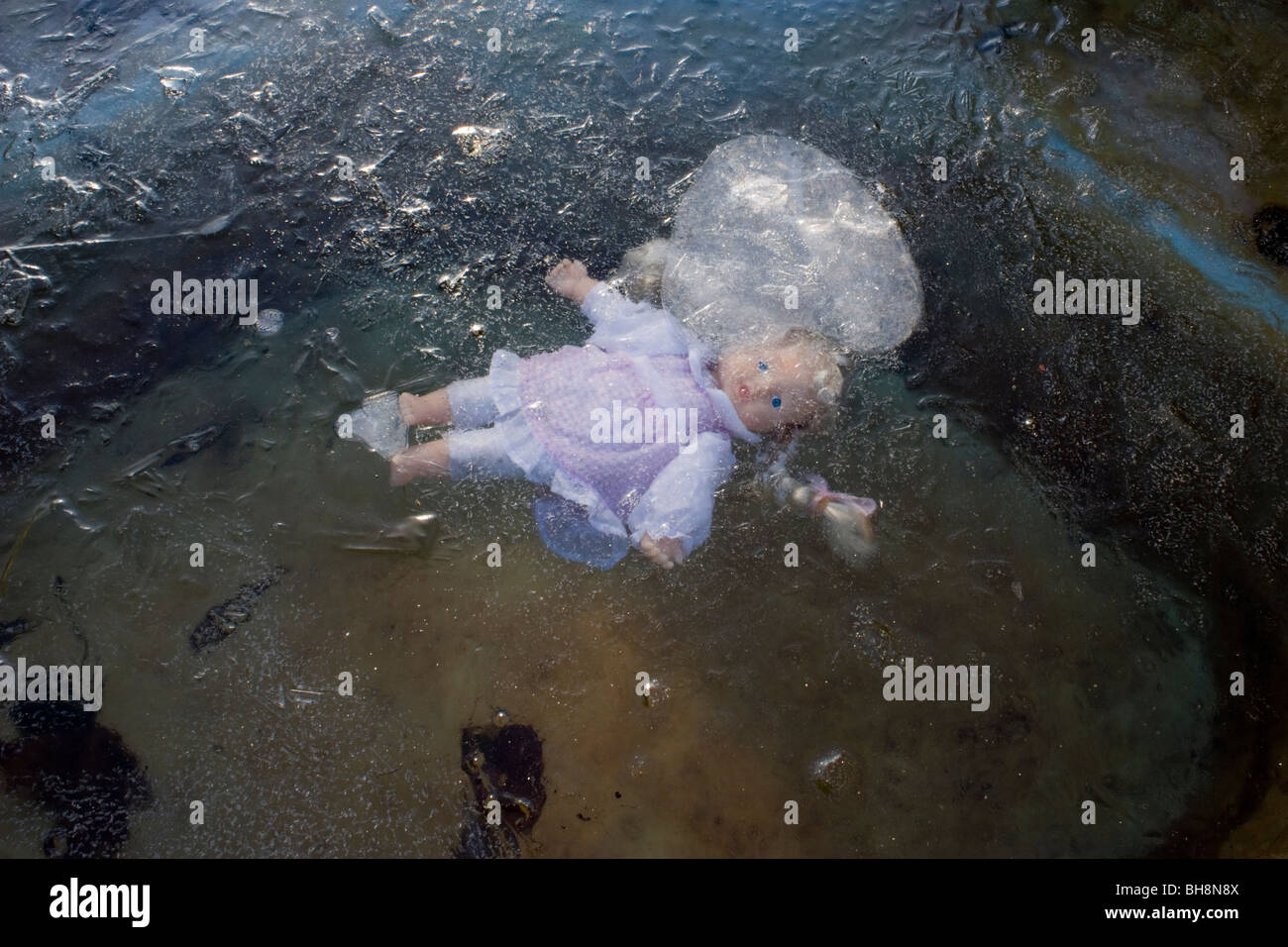 Doll trapped under ice Stock Photo - Alamy