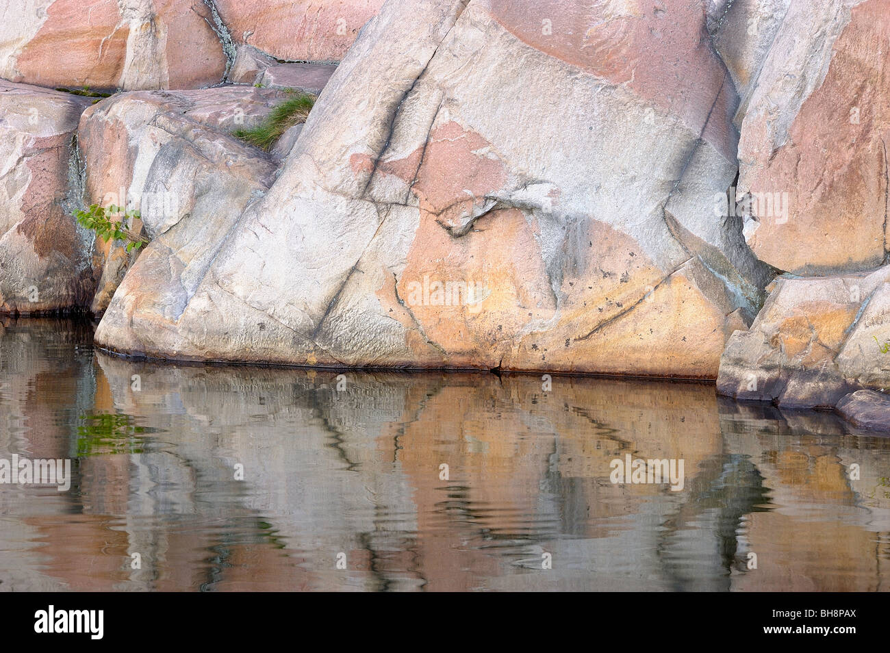 Granite cliff reflected in George Lake, Killarney Provincial Park ...
