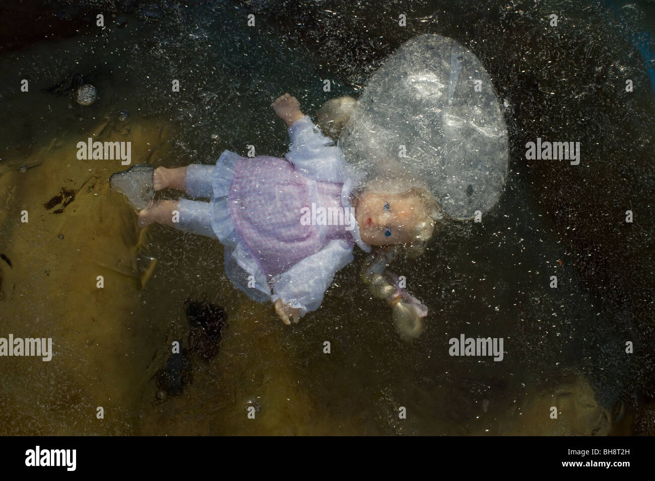 Doll trapped under ice Stock Photo - Alamy