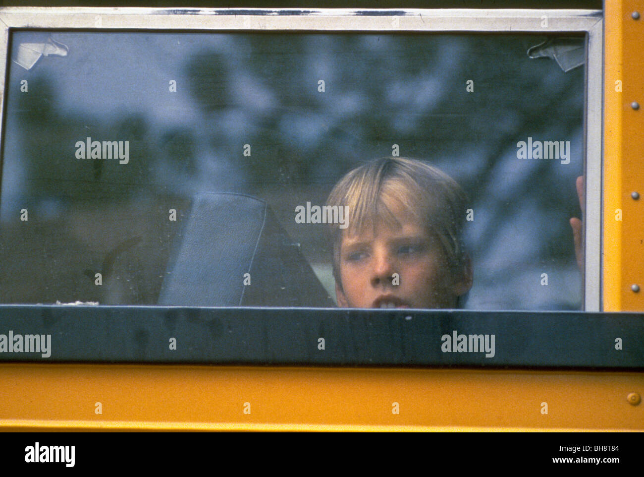boy bus sad worry unhappy look ride leave alone school Stock Photo - Alamy