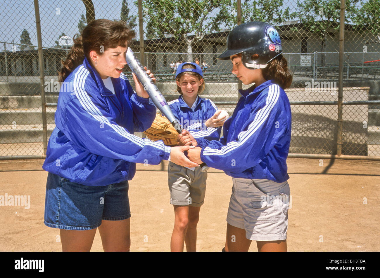 mom mother woman coach girl baseball teach Stock Photo - Alamy