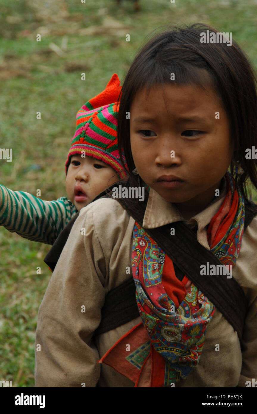 flower hmong girl looking after her baby sister , bac ha , lao cai ...