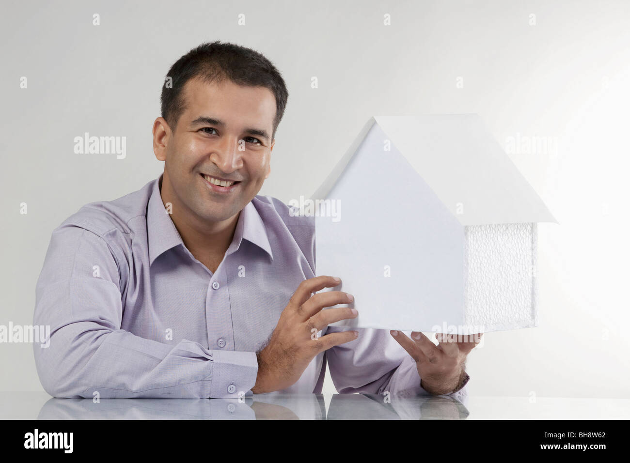 Man holding a house model Stock Photo - Alamy
