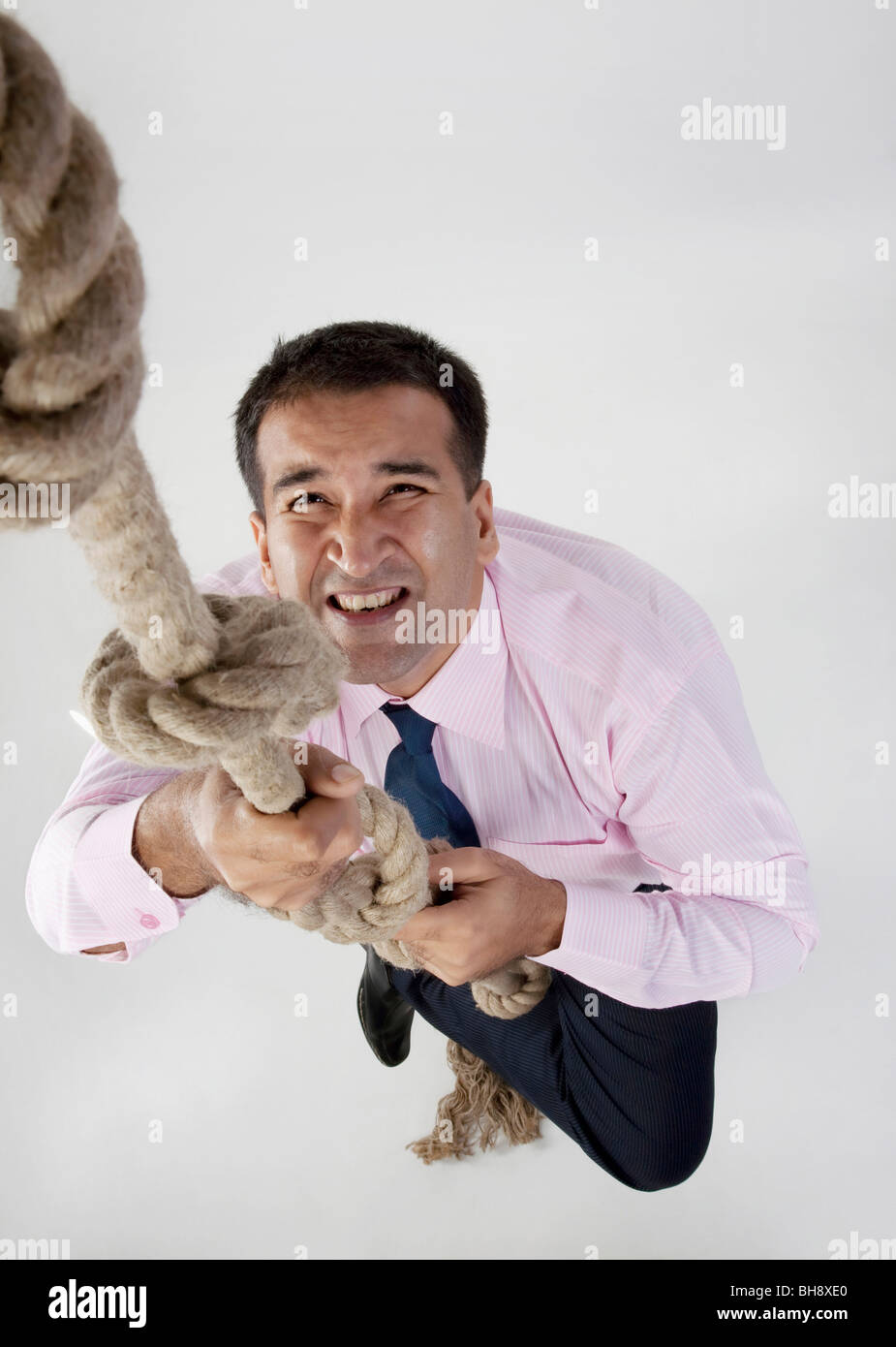 Businessman Trying To Climb A Rope Stock Photo Alamy businessman-trying-to-climb-a-rope-stock-photo-alamy