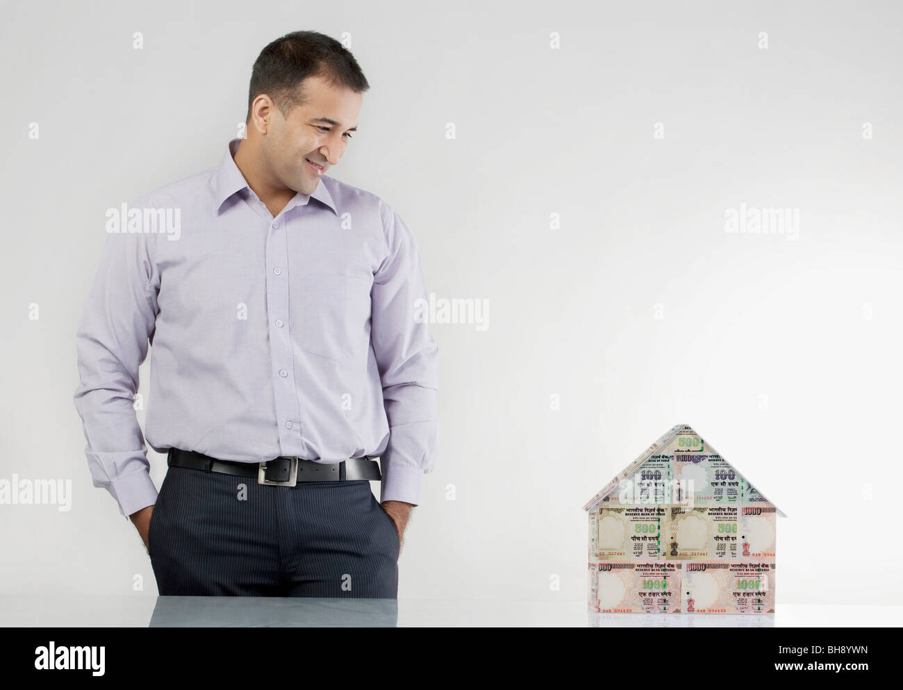 Man looking at a house model Stock Photo - Alamy