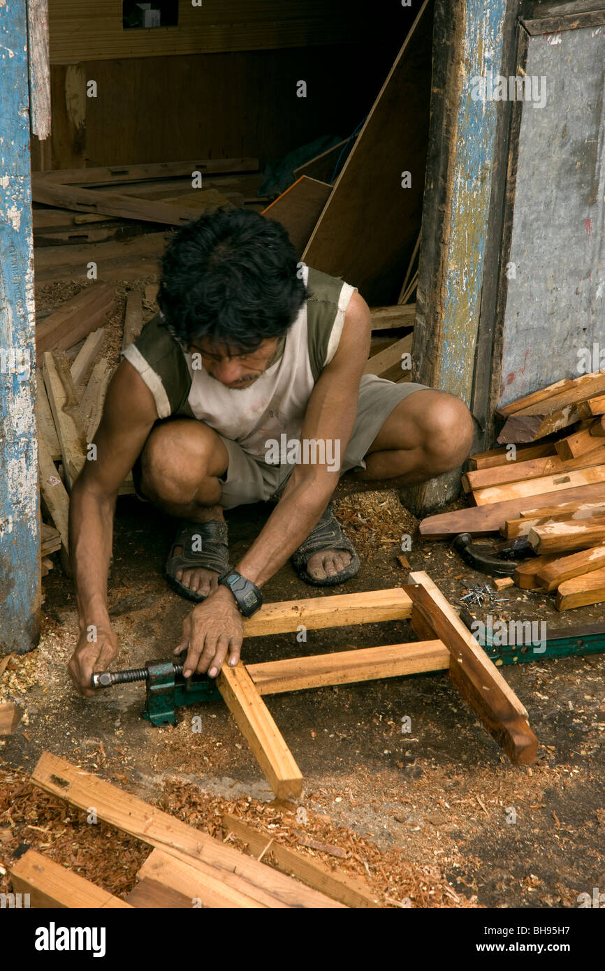 nepalese village carpenter using a vice making a chair in a village ...