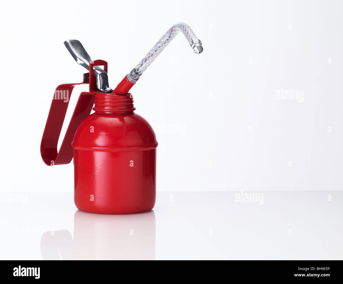 Traditional red oil can on a white background Stock Photo - Alamy