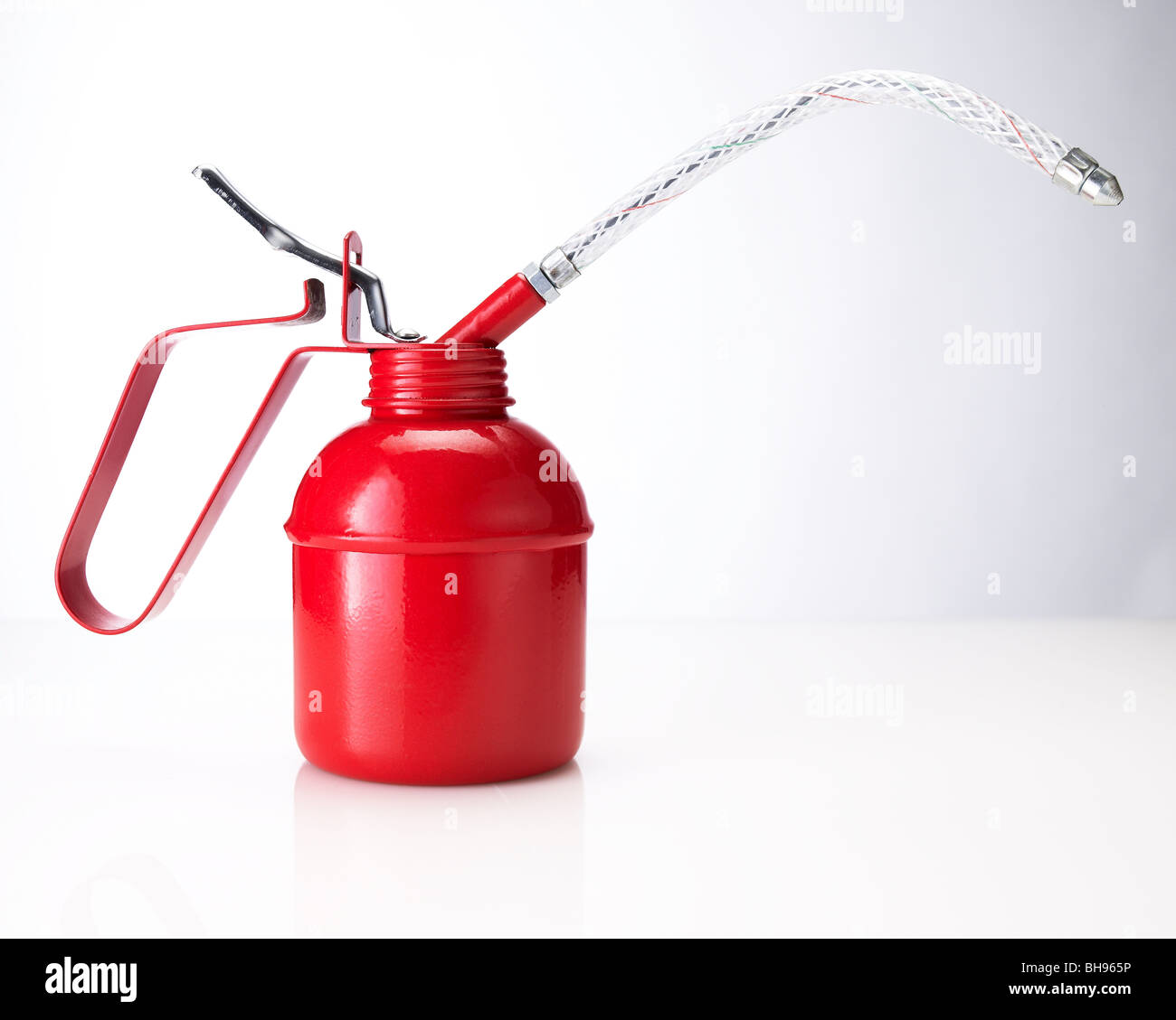 Traditional red oil can on a white background Stock Photo - Alamy