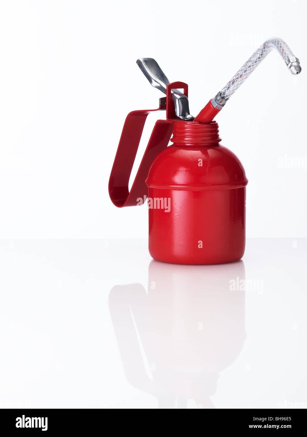 Traditional red oil can on a white background Stock Photo - Alamy