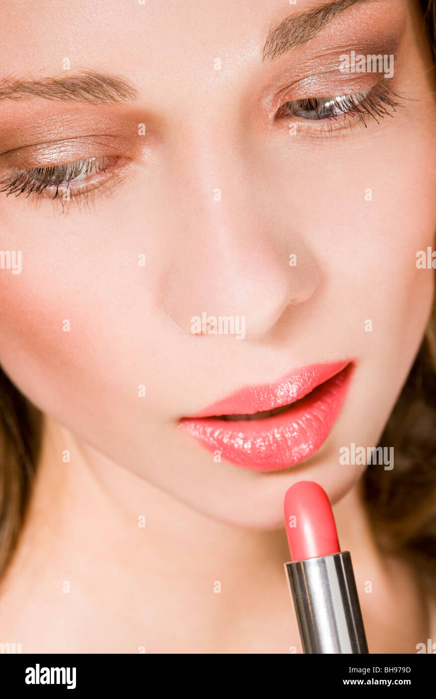beauty woman applying pink lipstick Stock Photo - Alamy