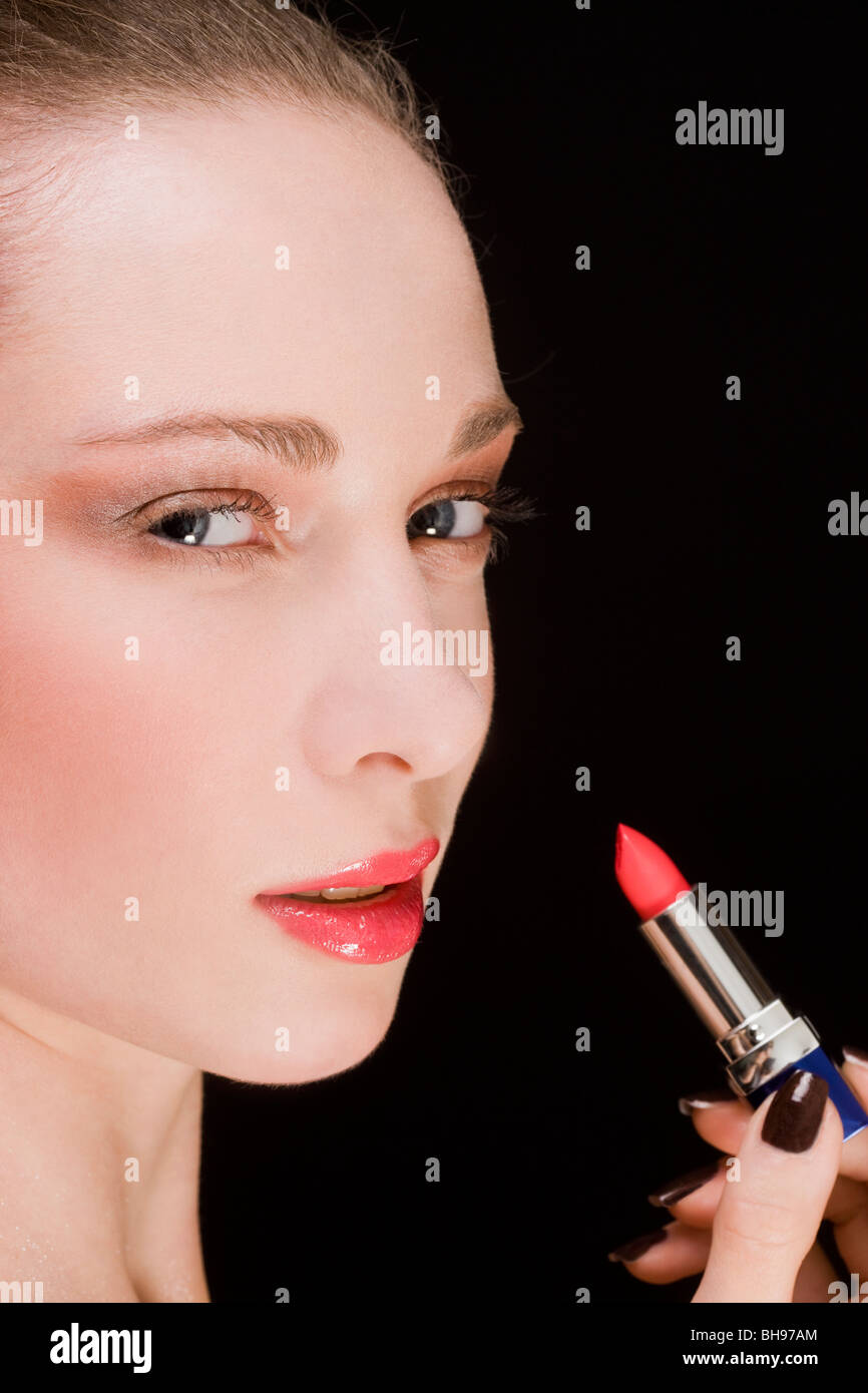 beauty woman applying pink lipstick Stock Photo - Alamy