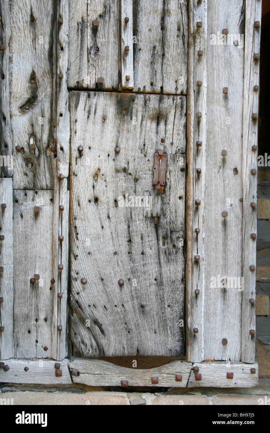 Detail of an ancient oak studded door within a door at Haddon Hall in ...