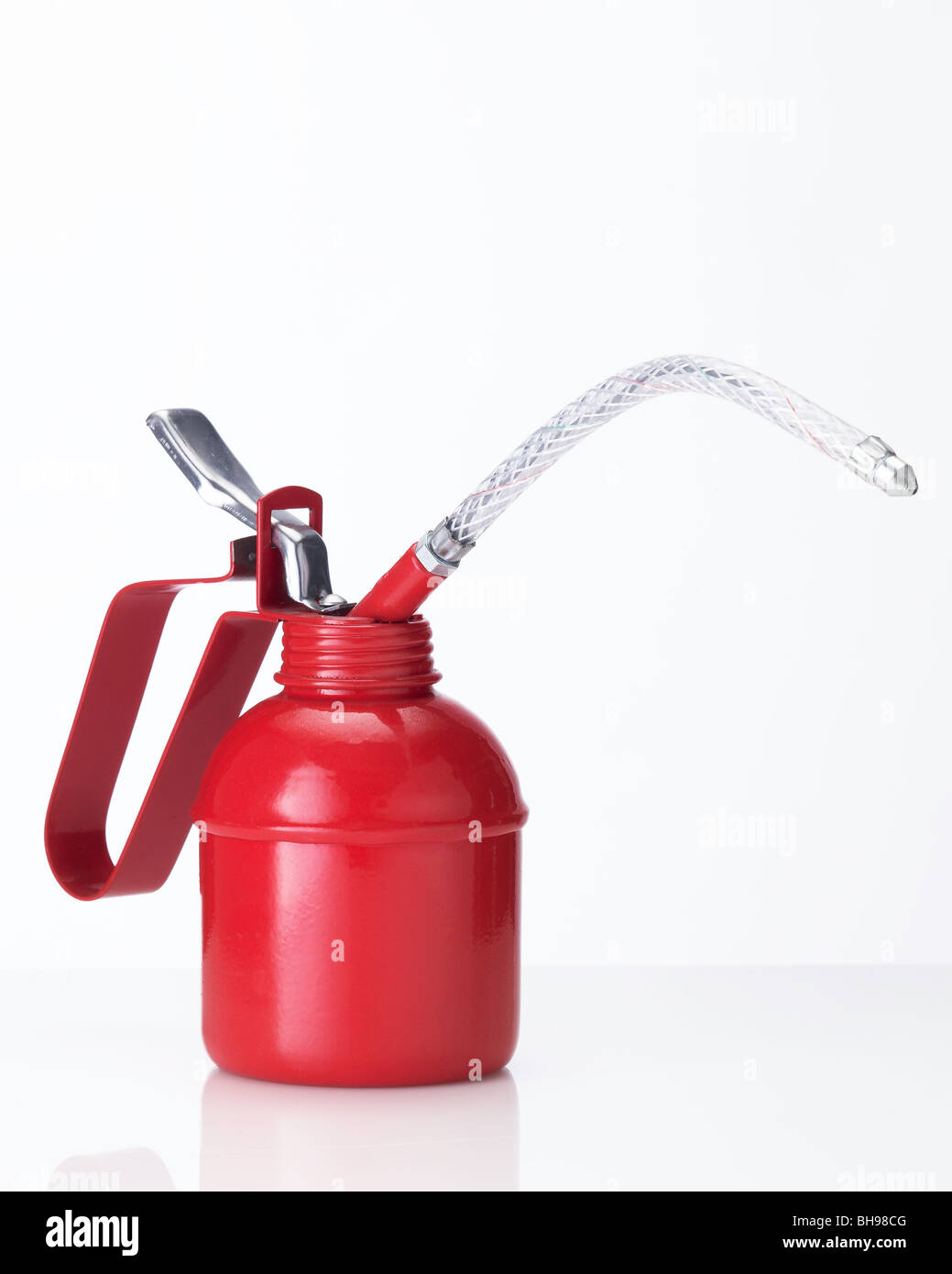 Traditional red oil can on a white background Stock Photo - Alamy
