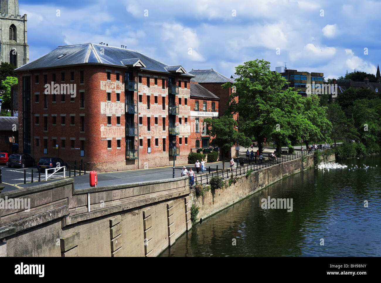 converted mill and industrial buildings alongside the river severn in ...
