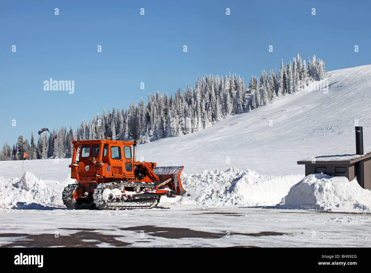 Caterpillar bulldozer push snow off mountain road central Utah. Tracked ...