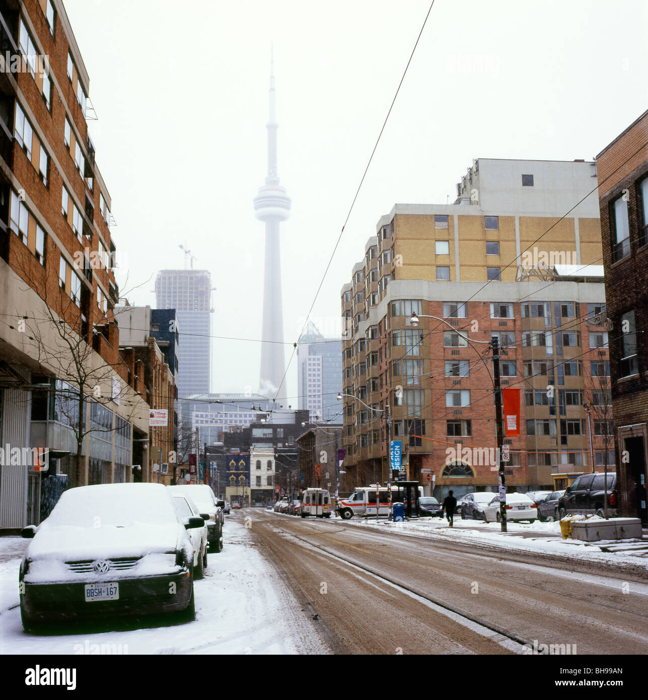 Snow on parked cars and tram lines n McCaul Street and CN Tower Toronto ...