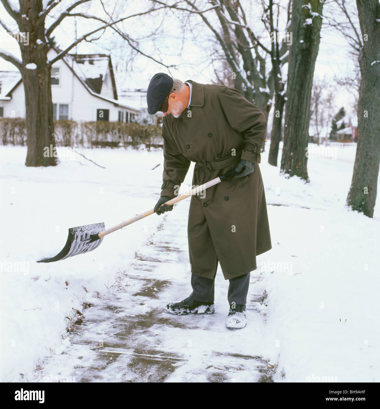 Elderly man shoveling sidewalk Fort Erie Ontario Canada Stock Photo - Alamy