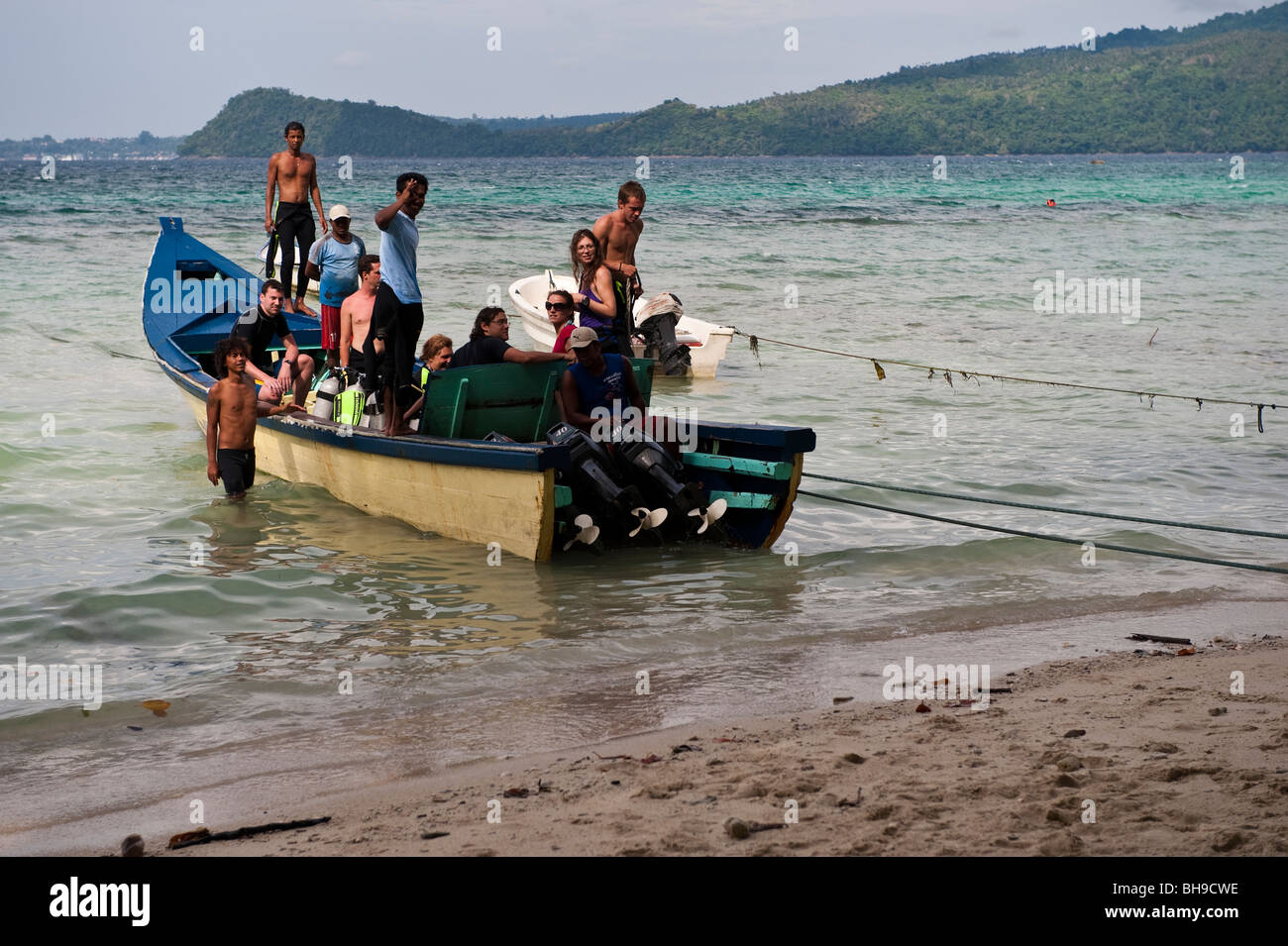 A group unloading a boat after a dive, Gapang Beach, Pulau Weh, Sumatra ...