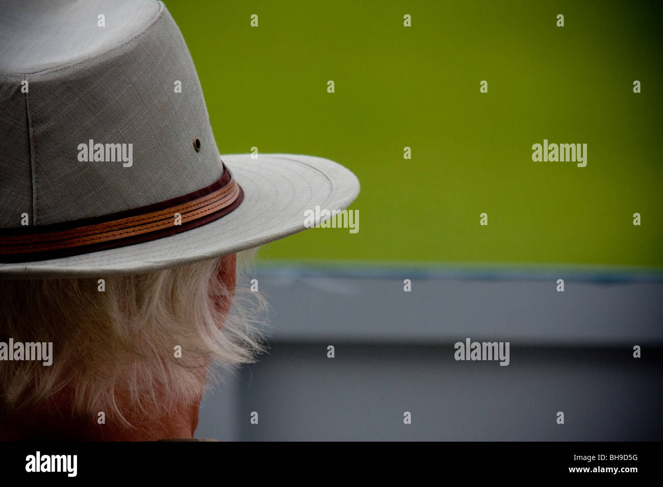 Man in hat sat watching the cricket Stock Photo - Alamy