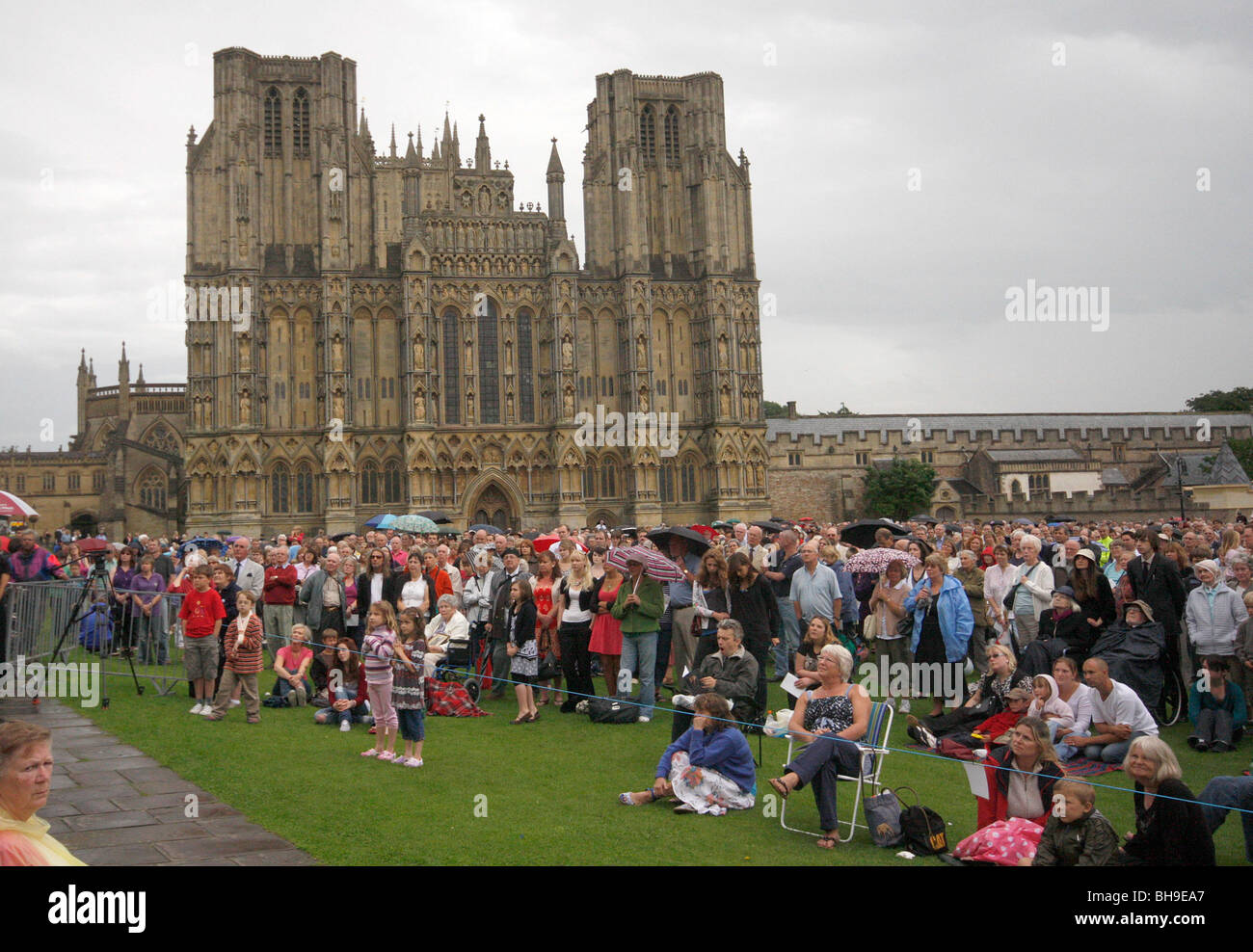 Mourners watch the funeral of war veteran Harry Patch on a big screen ...