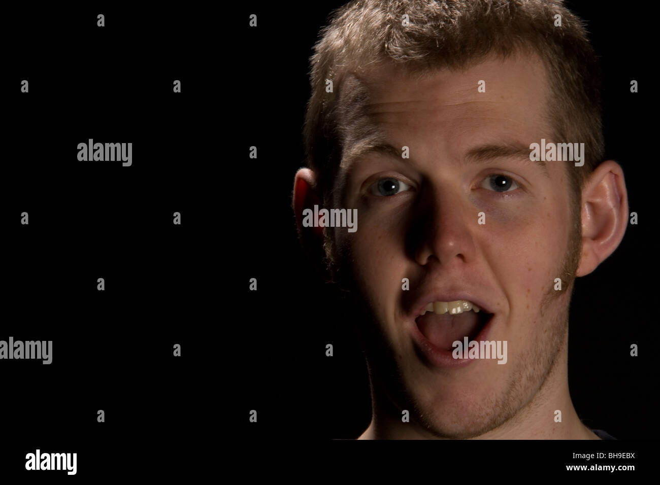 Man in photographic studio pulling facial expression Stock Photo - Alamy