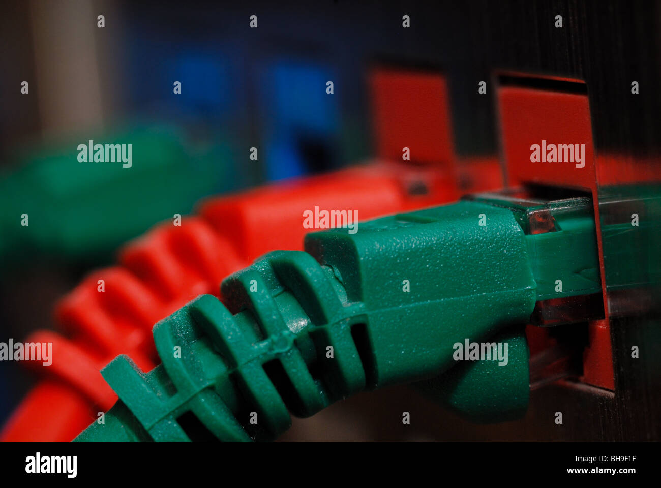 Different colored ethernet cables plugged into wall outlets Stock Photo ...