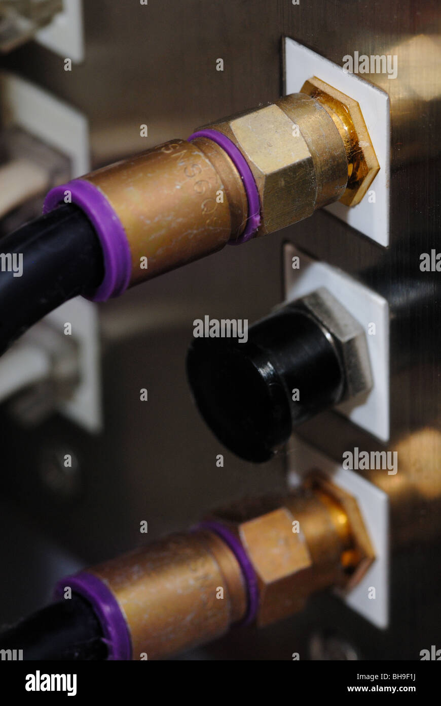 Coax cables and wires plugged into a wall outlet Stock Photo - Alamy