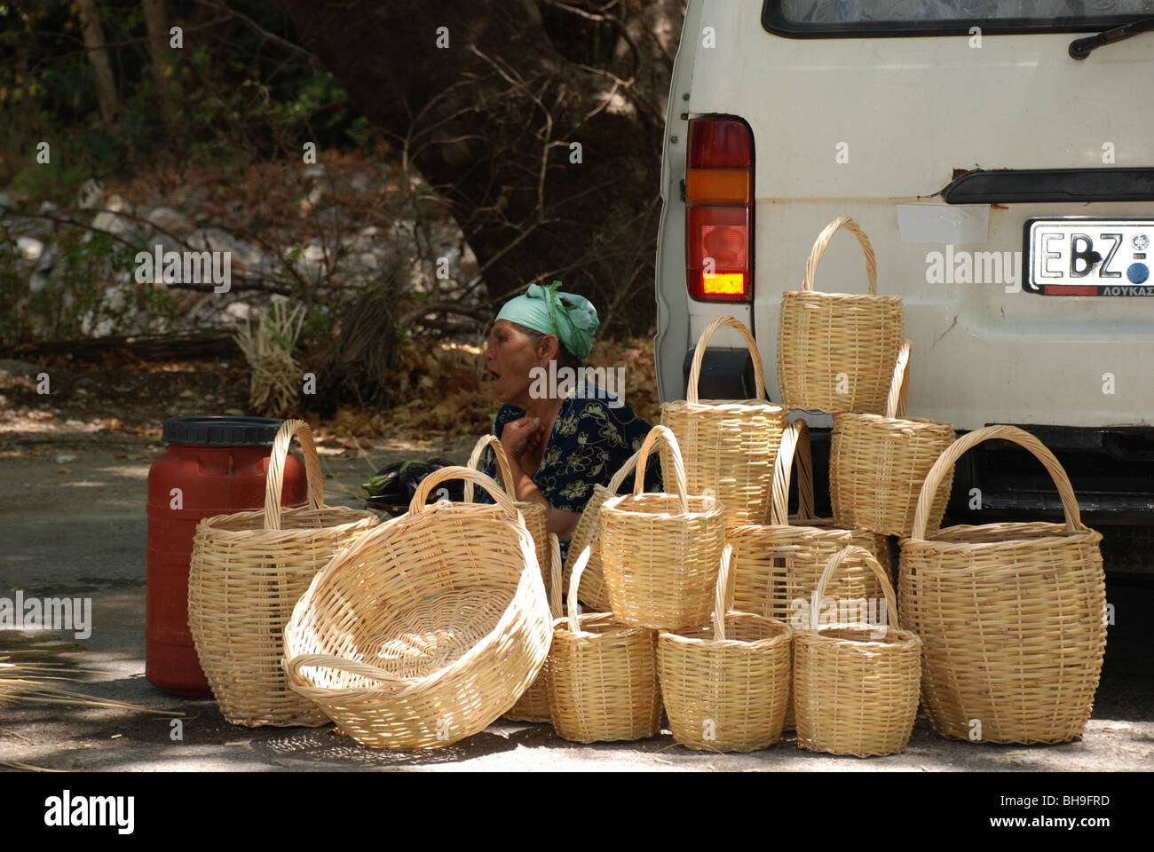 a gypsy woman selling her baskets Stock Photo - Alamy