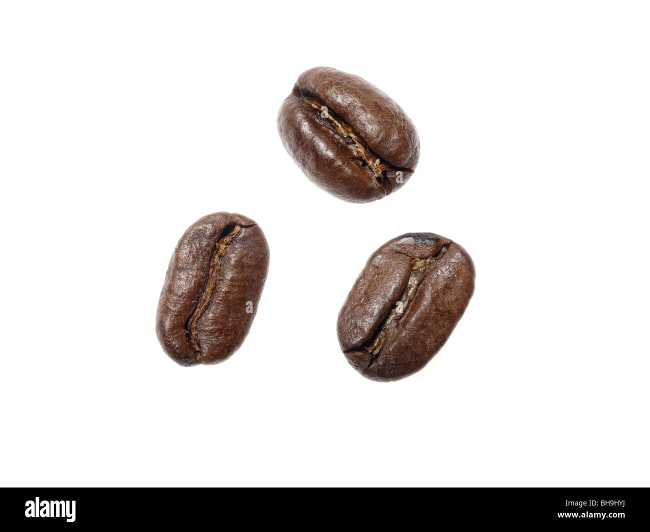Three coffee beans shot over white background Stock Photo - Alamy