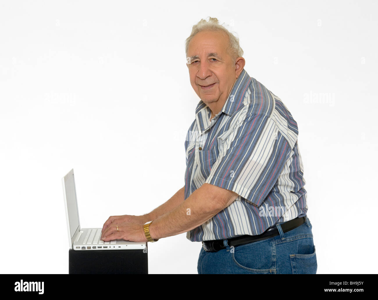 A senior retired elderly gentleman types on a computer Stock Photo - Alamy