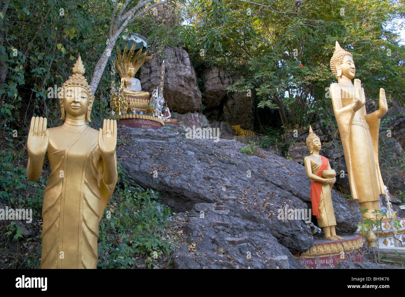 LAOS STATUES ON A ROCK AT A BUDDHIST MONASTERY IN THE HOLY CITY OF ...