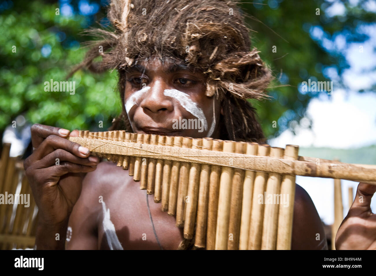 A native boy plays a hand made traditional mouth harp Nggela Solomon ...