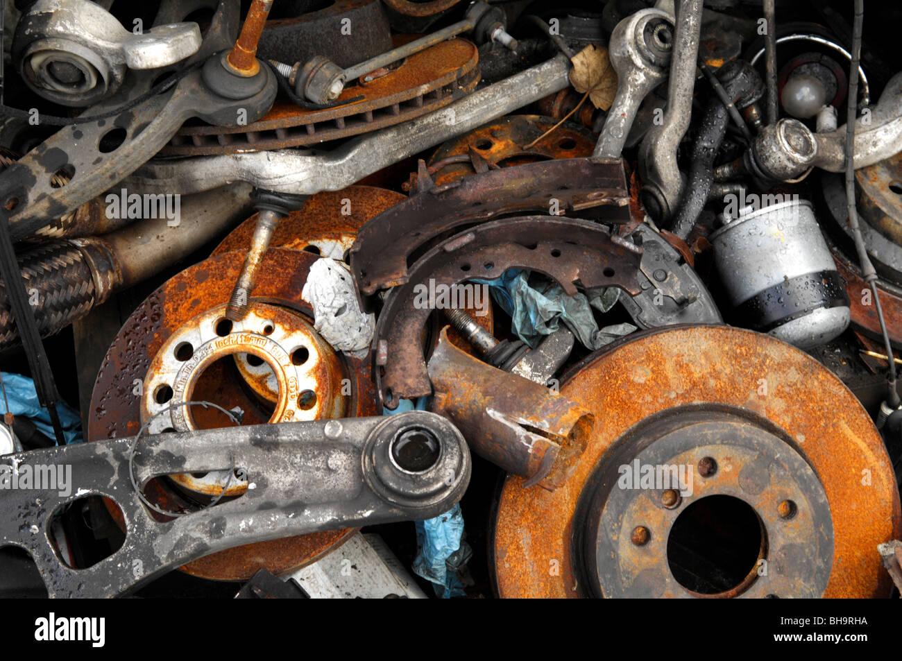 Rusty car parts dumped Stock Photo - Alamy