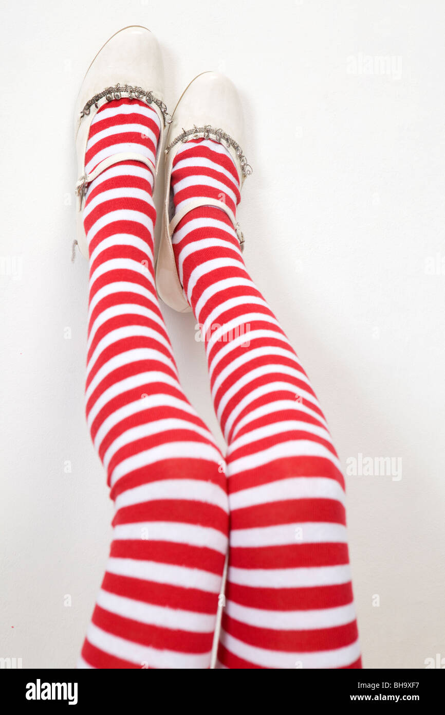 head over heels. female legs in stripy stockings; isolated on white ...