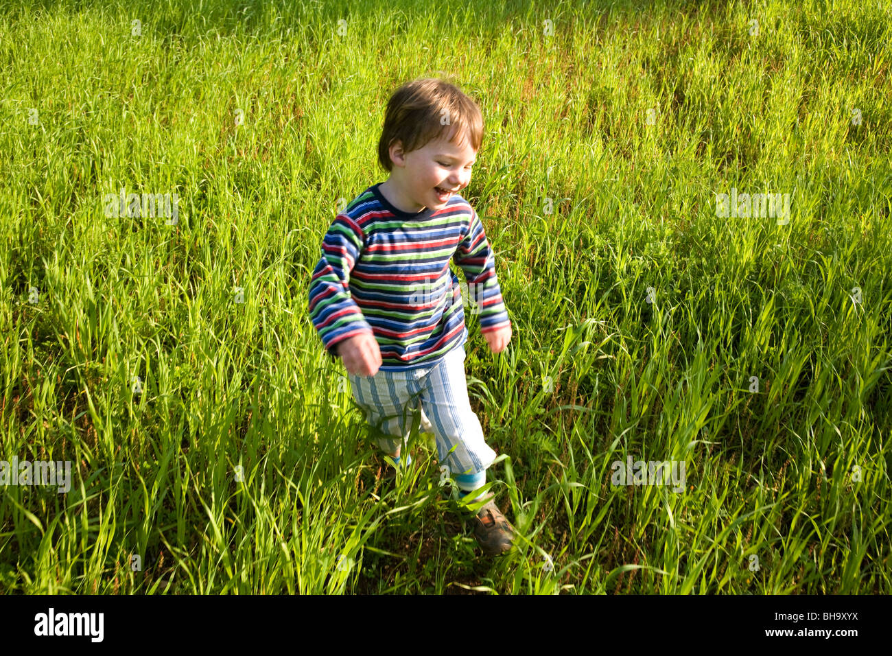 Little boy running in grass (high angle view Stock Photo - Alamy