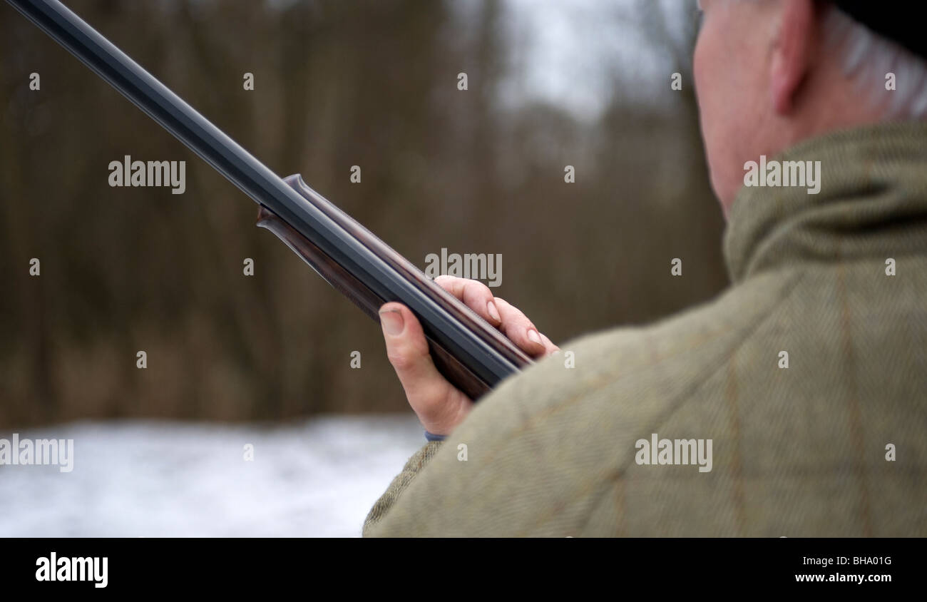 man waiting to shoot 20 bore over and under shotgun Stock Photo - Alamy