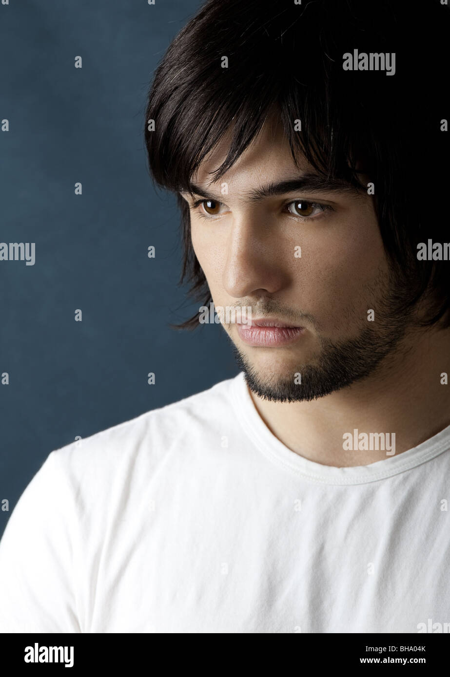Picture of Good looking young man portrait over a blue background Stock ...