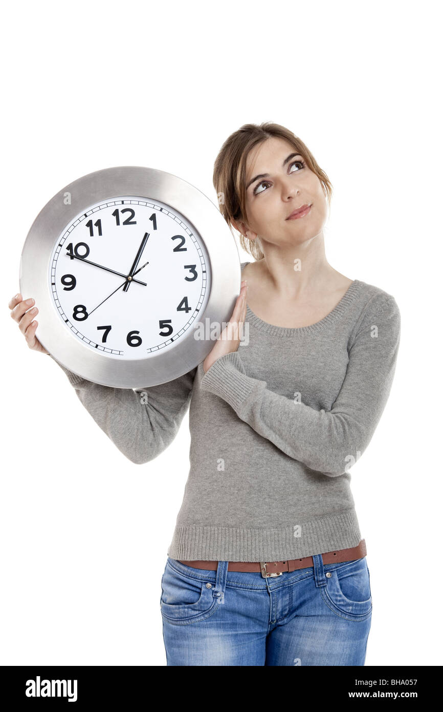 Beautiful woman standing over a white background holding a clock Stock ...