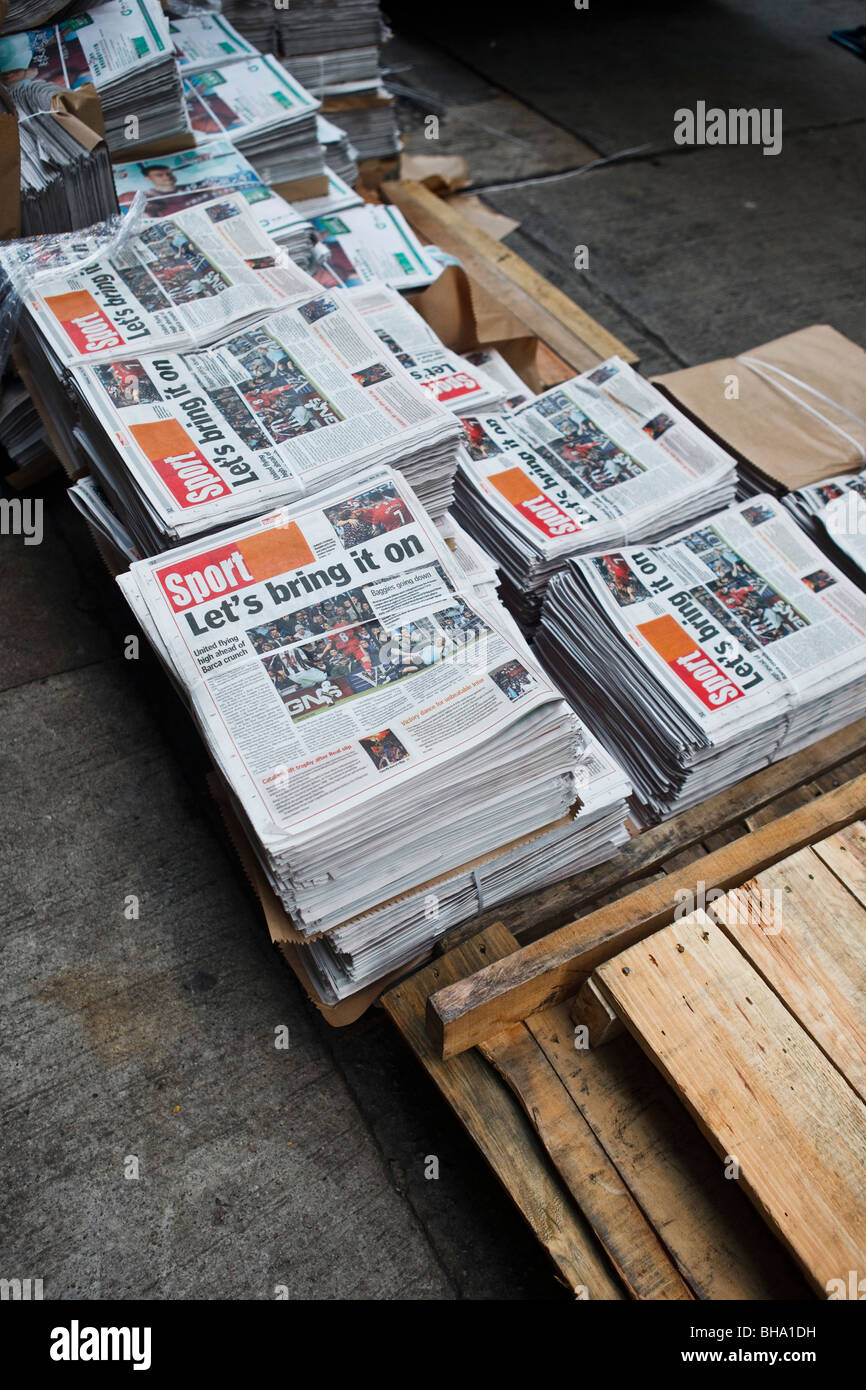 A stack of newspapers made ready for delivery and distribution in Hong ...