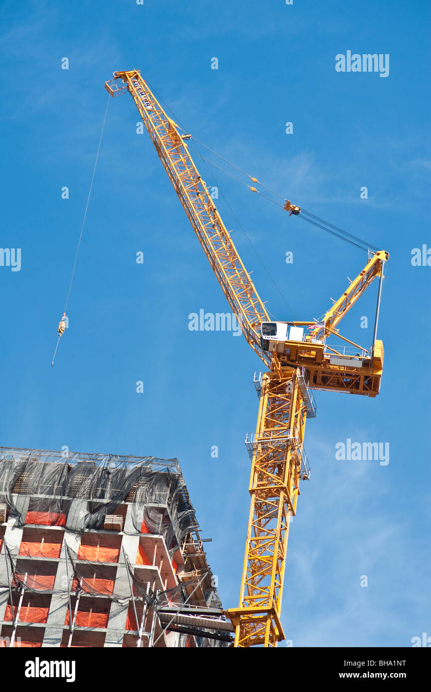 Construction cranes at work putting up high rise buildings Stock Photo ...