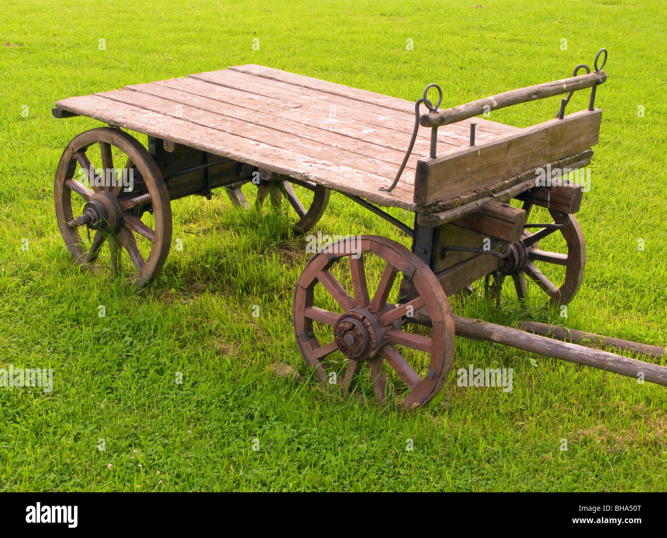 old-fashioned wooden cart in a green grass field, Russia farm Stock ...