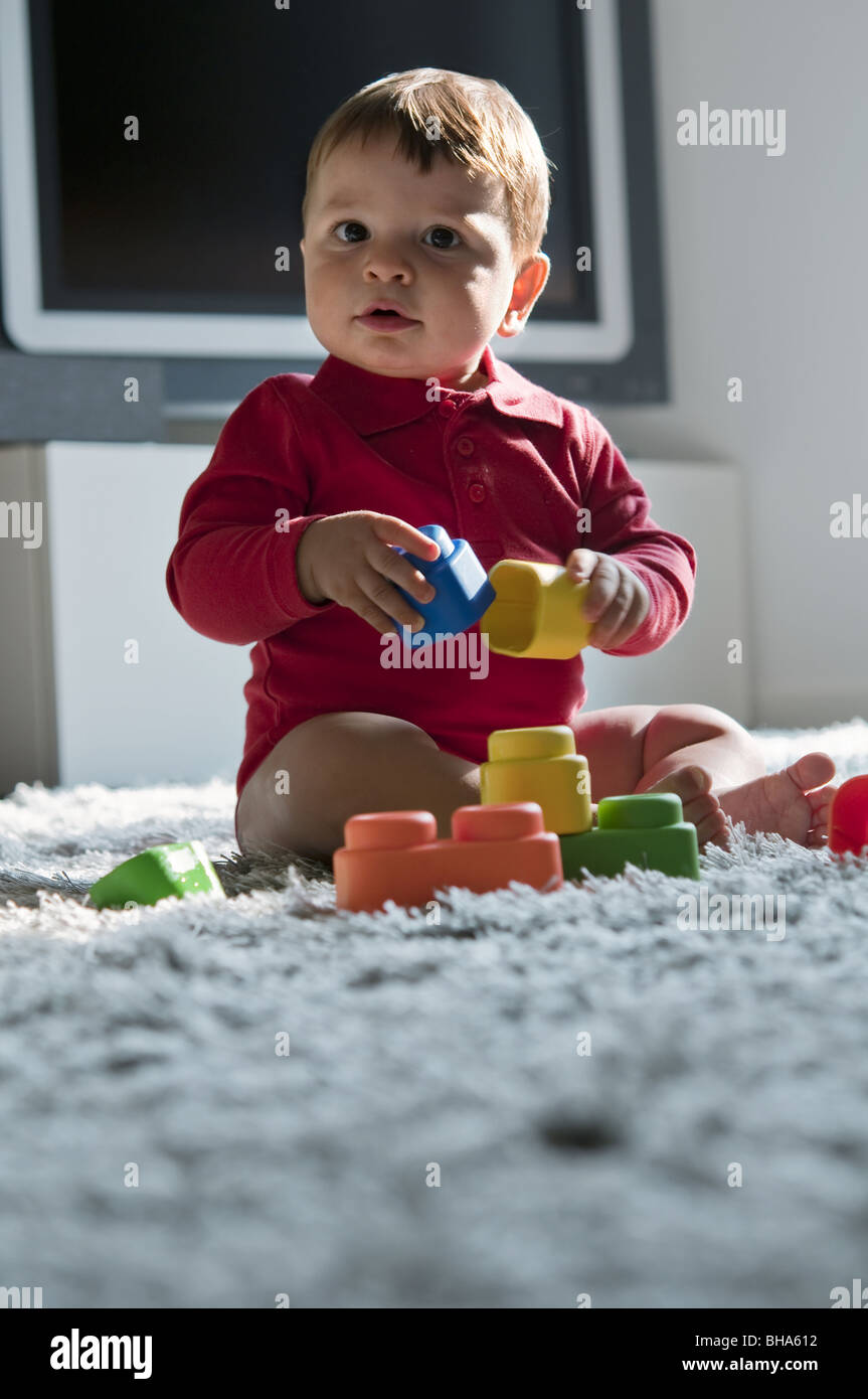 Baby boy playing with toys Stock Photo - Alamy