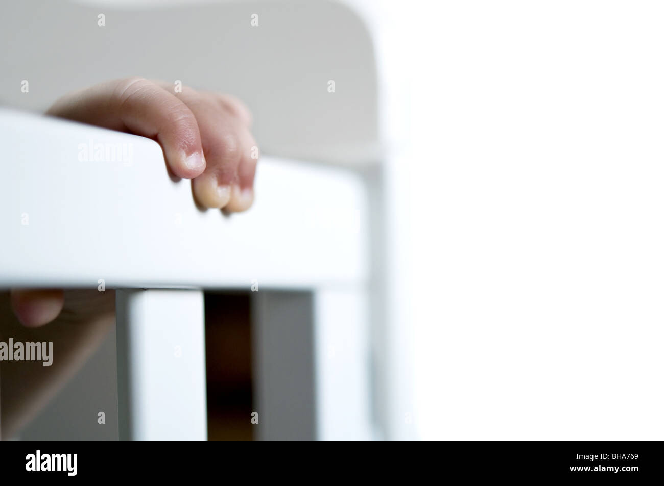Baby's hand on crib Stock Photo - Alamy