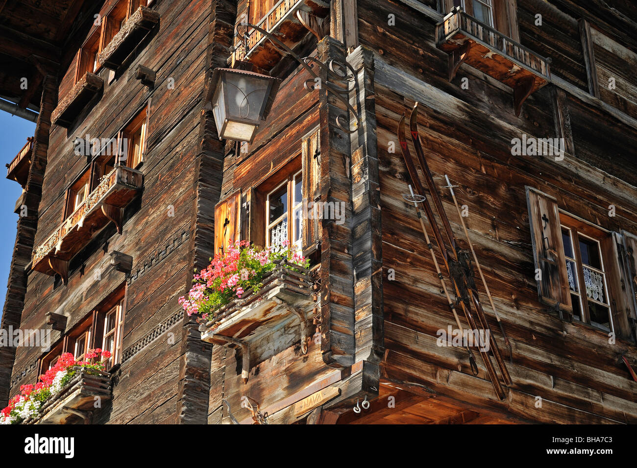 Traditional Swiss wooden house / chalet decorated with old skis and ...