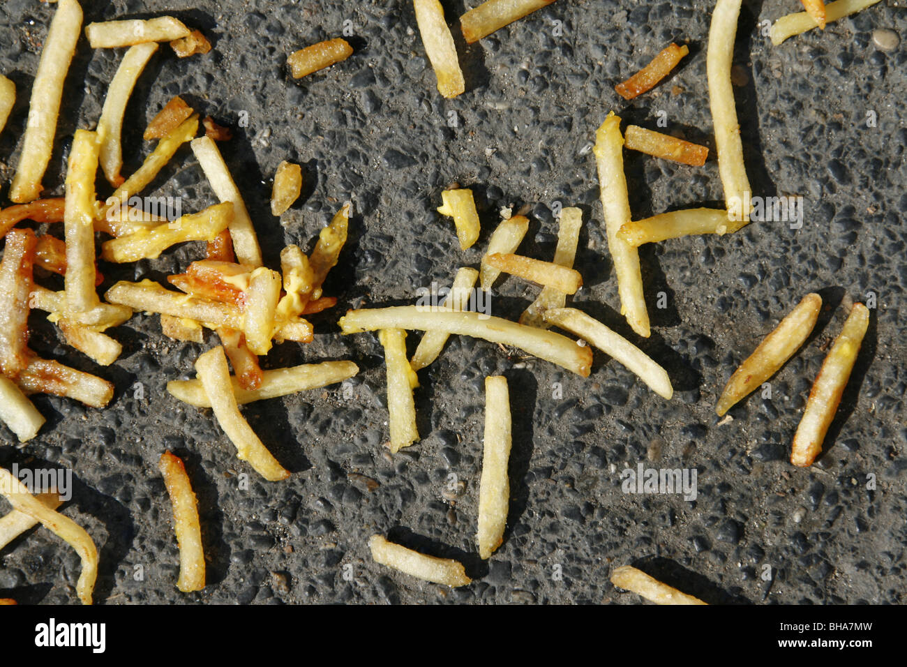 lots of french fries chips on street in sun Stock Photo - Alamy
