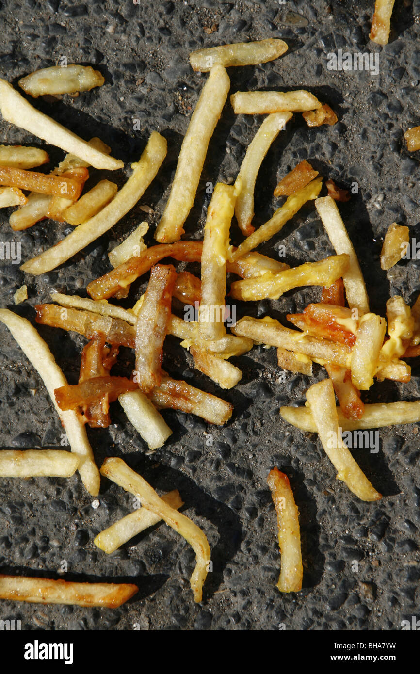 lots of french fries chips on street in sun Stock Photo - Alamy