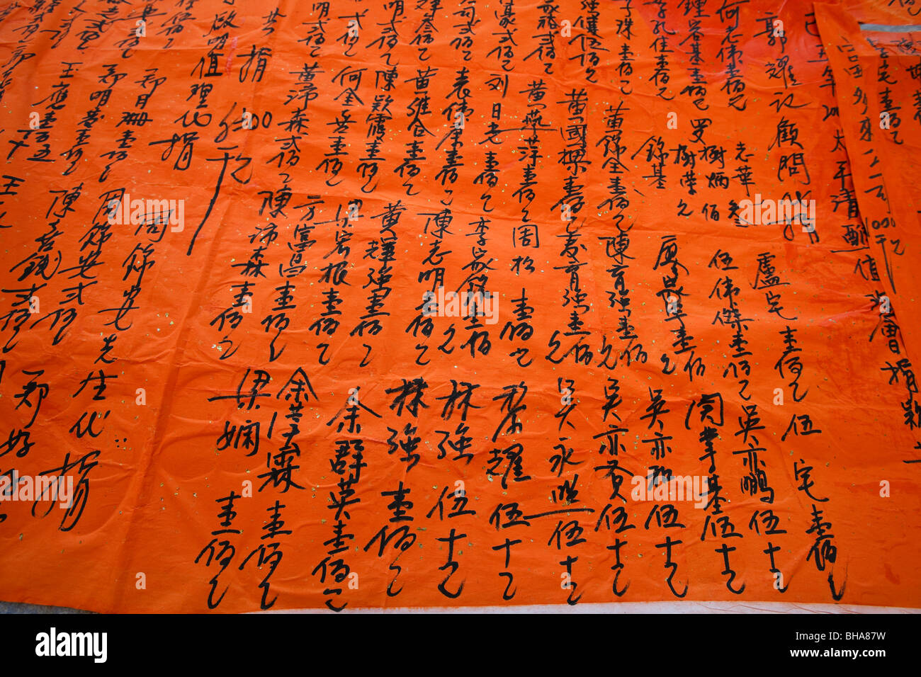 An orange paper banner with hand written Chinese writing Stock Photo ...