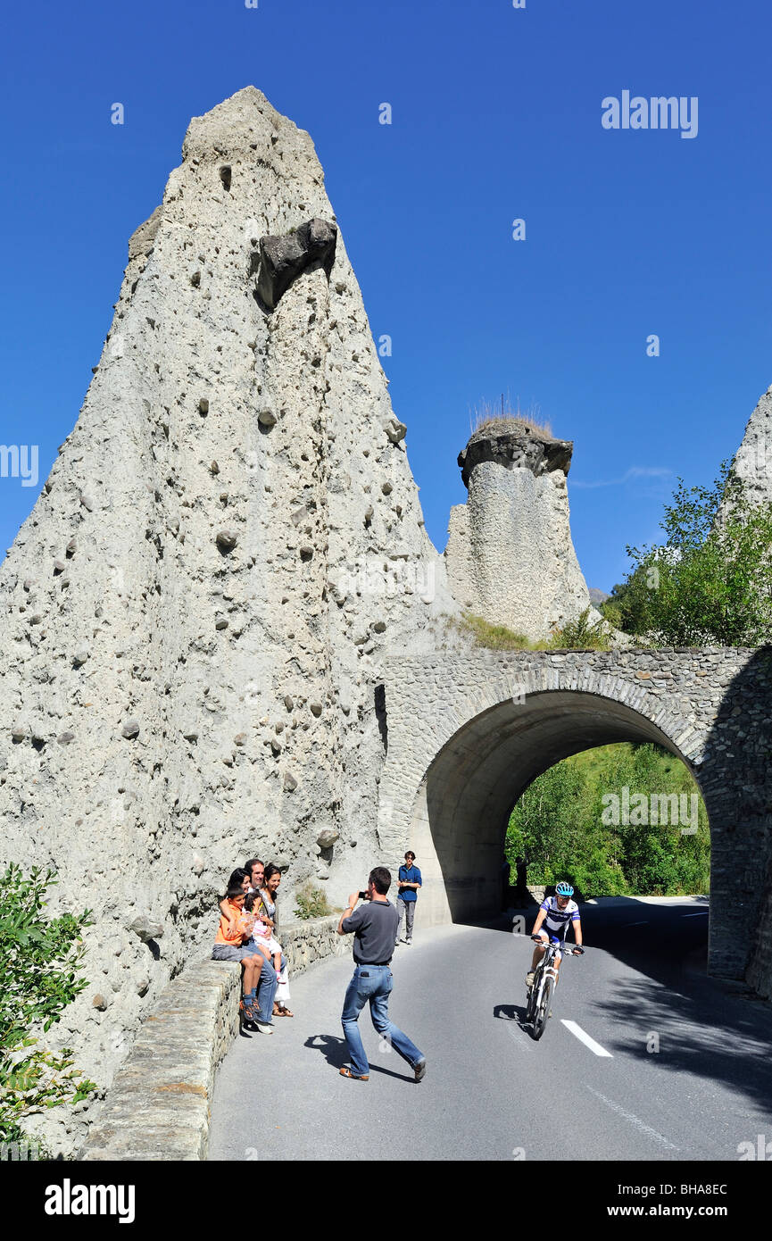 Tourists visiting Pyramids of Euseigne, strange rock formations created ...