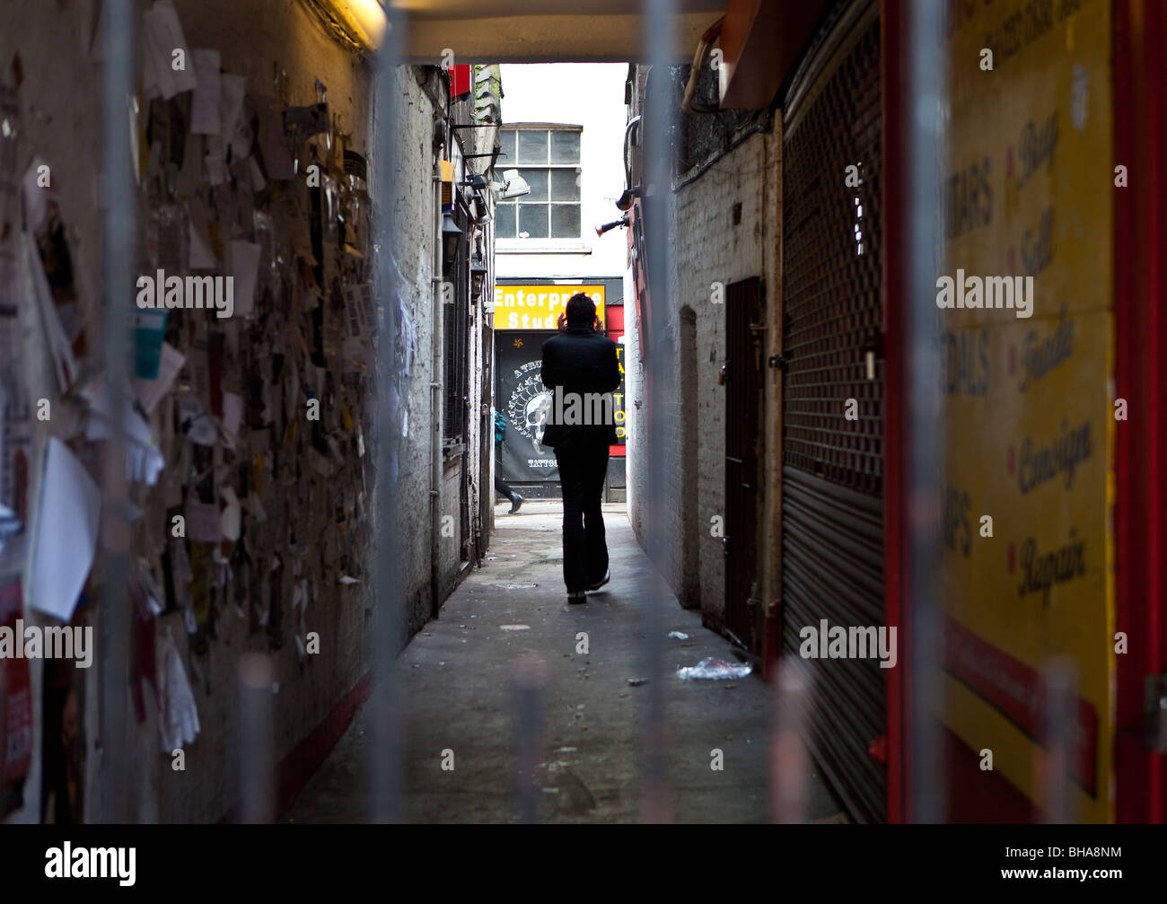 Man walking through alleyway Stock Photo - Alamy