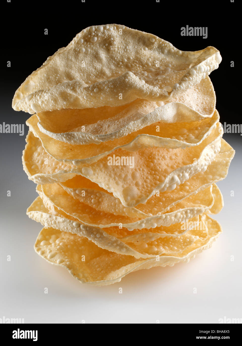 A pile of poppadoms on a white background Stock Photo - Alamy